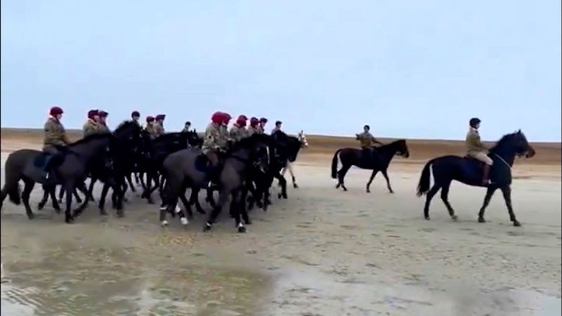 Household Cavalry make a splash at the beach during training session ahead of summer duties