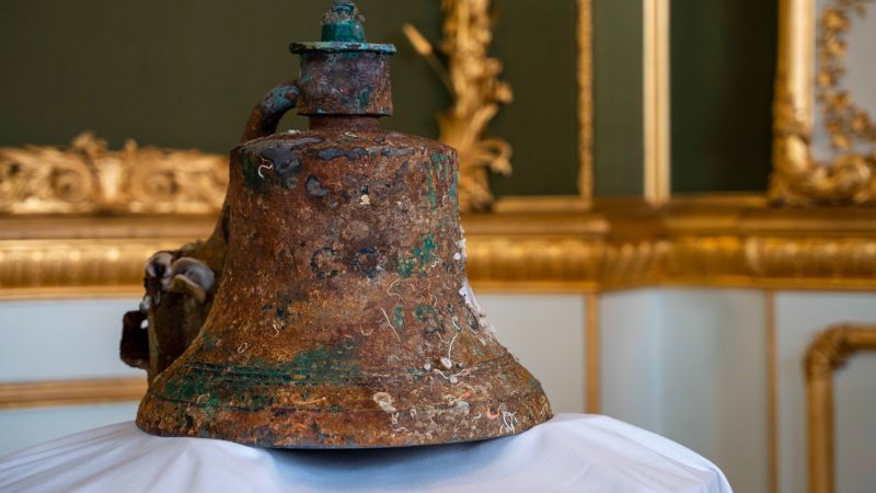 Historic bell recovered by British divers from sunken wreck returned to ...